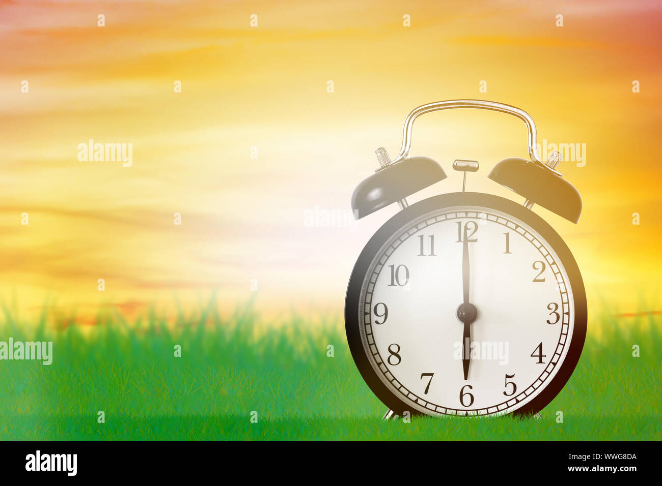 Good morning and wake up concept, alarm clock on green grass Stock ...