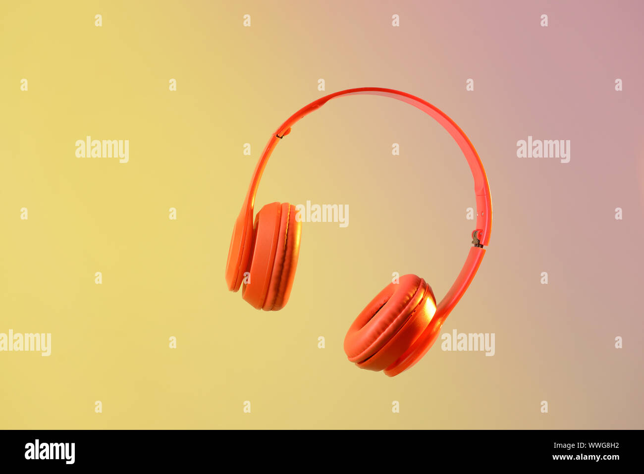 Modern headphones on color background Stock Photo - Alamy