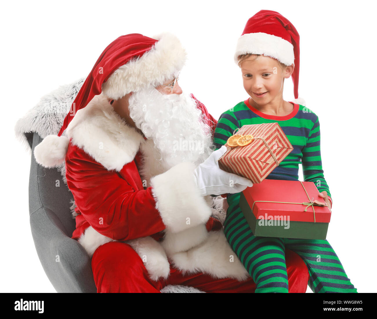 Santa Claus and little elf kid with gifts against white background ...