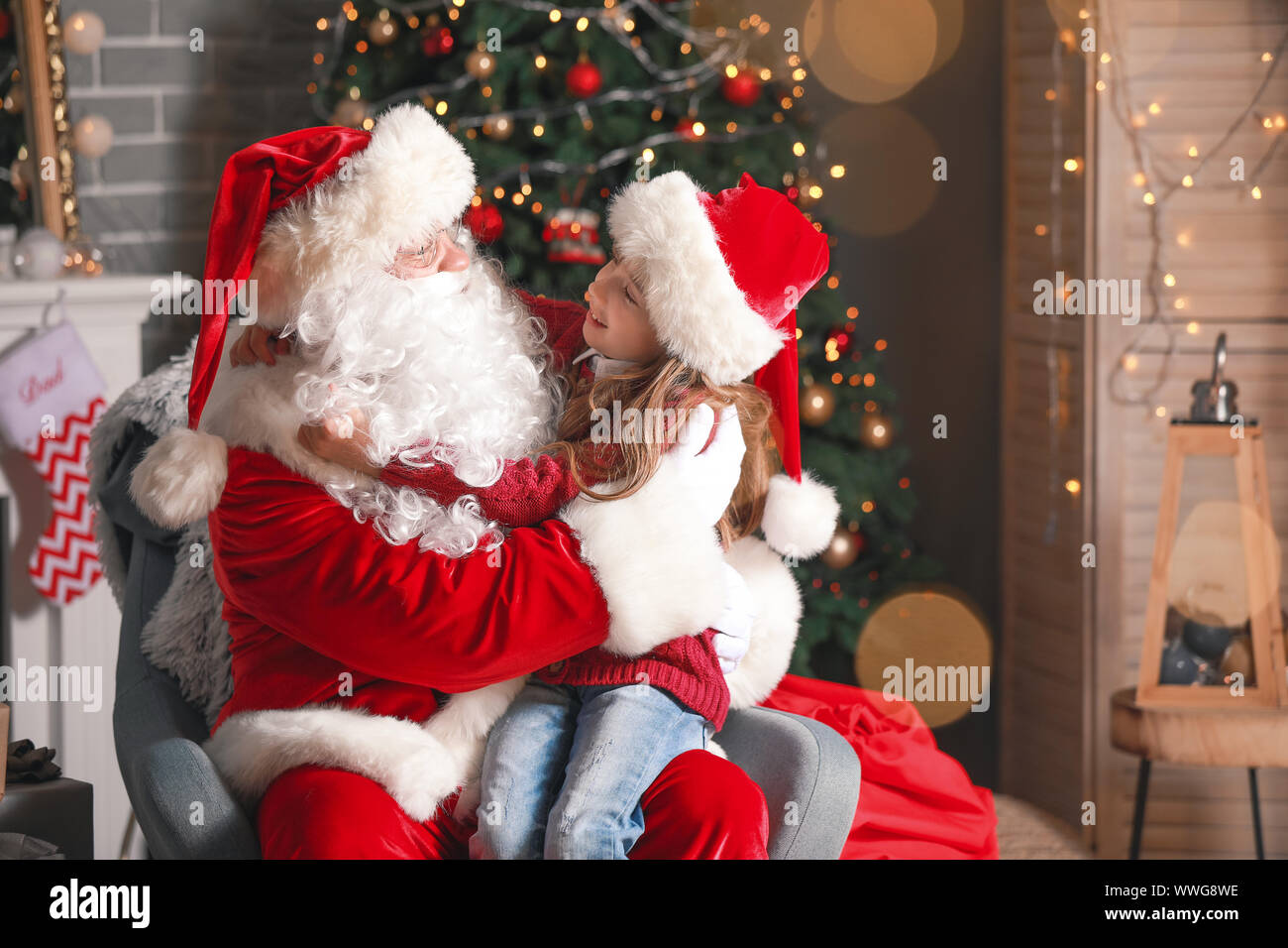 Santa claus hugging little girl hi-res stock photography and images - Alamy