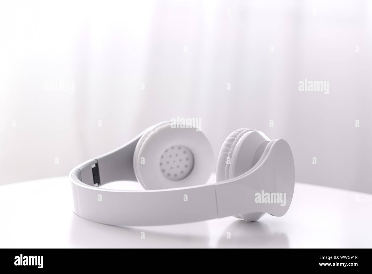 Modern headphones on table in room Stock Photo - Alamy
