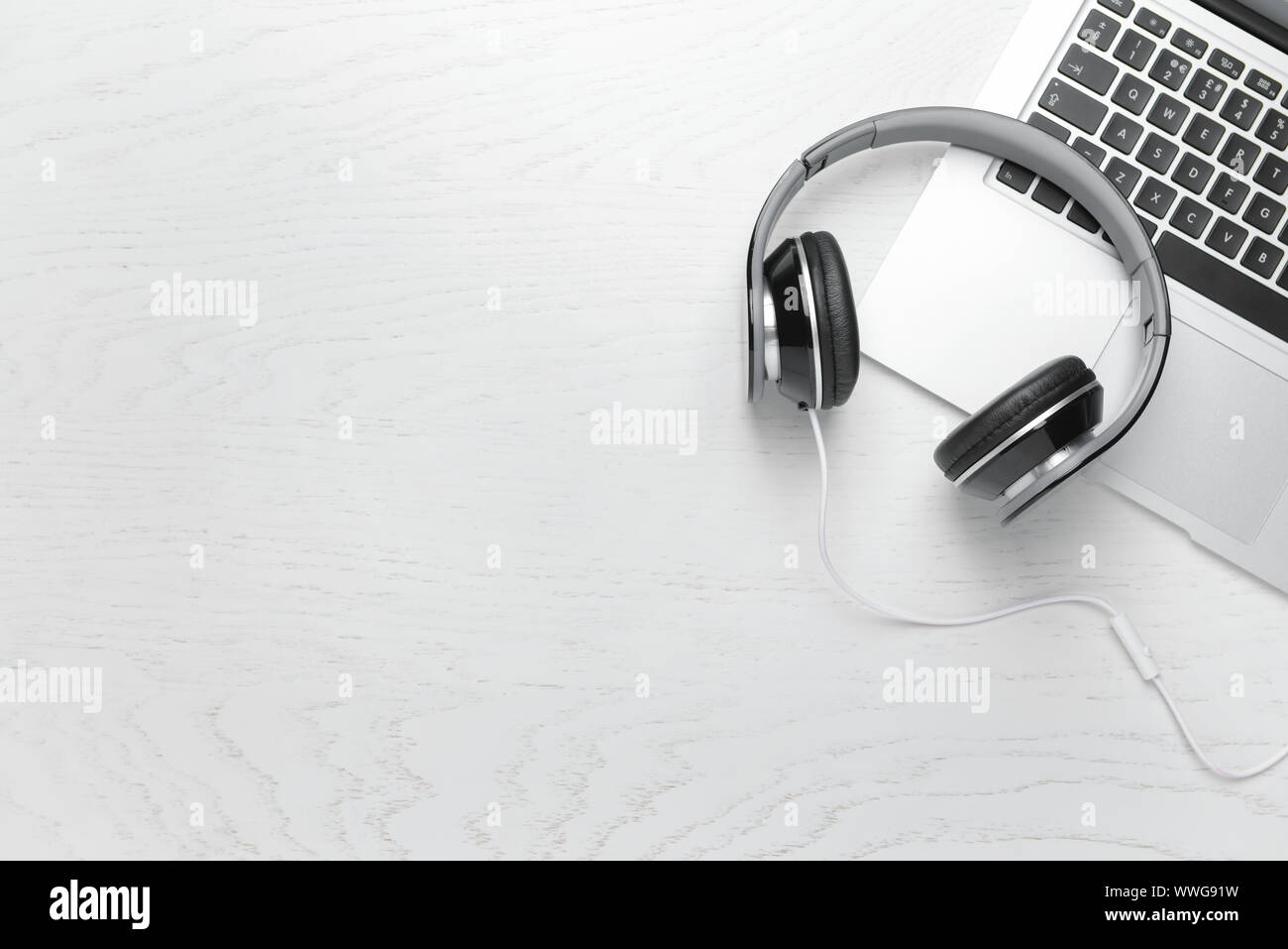 Modern headphones and laptop on white background Stock Photo - Alamy