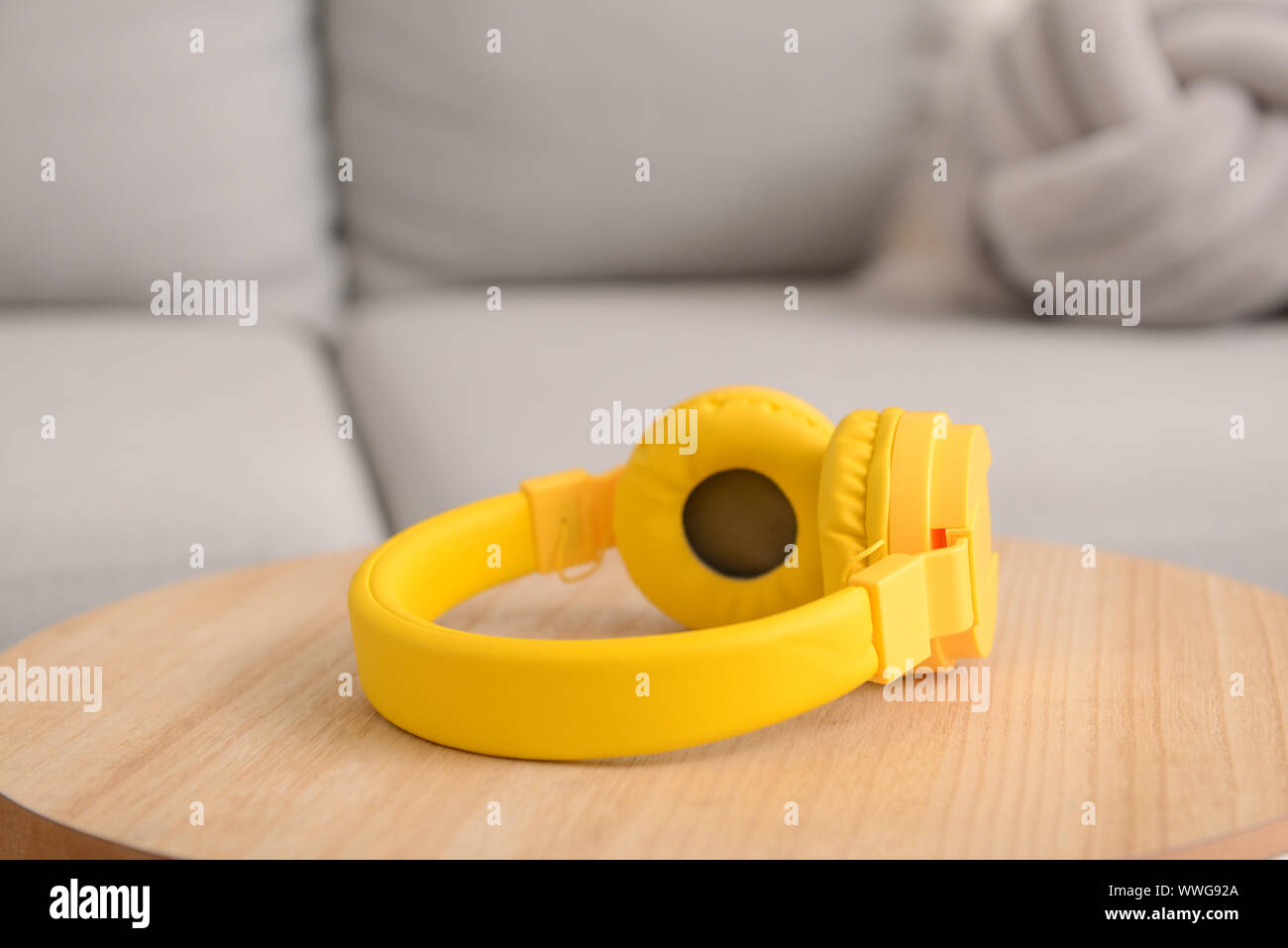 Modern headphones on table in room Stock Photo - Alamy