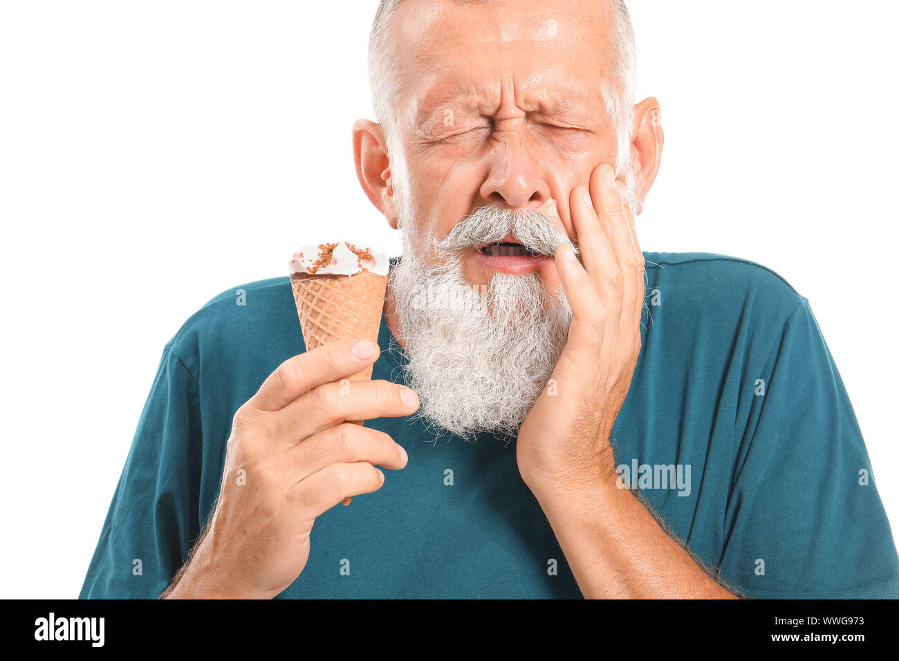 Senior man with sensitive teeth and cold ice-cream on white background ...