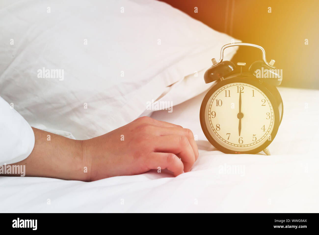 Good morning and wake up concept, alarm clock on the bed, time to work ...