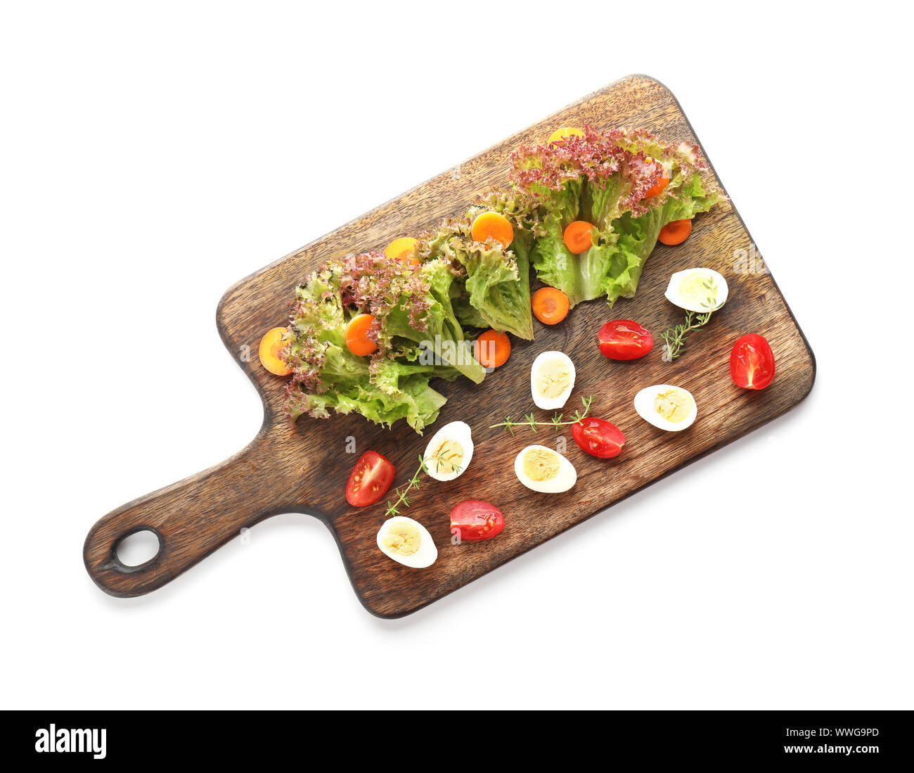 Wooden board with quail eggs and vegetables on white background Stock ...