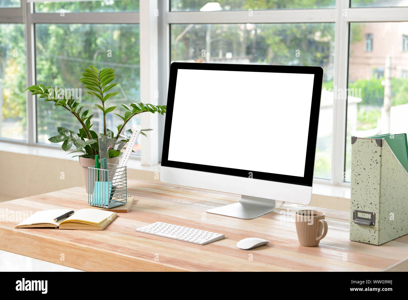 Stylish workplace with modern computer near window Stock Photo - Alamy