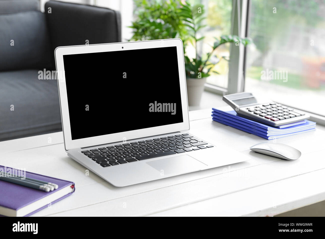 Stylish workplace with modern laptop in office Stock Photo - Alamy