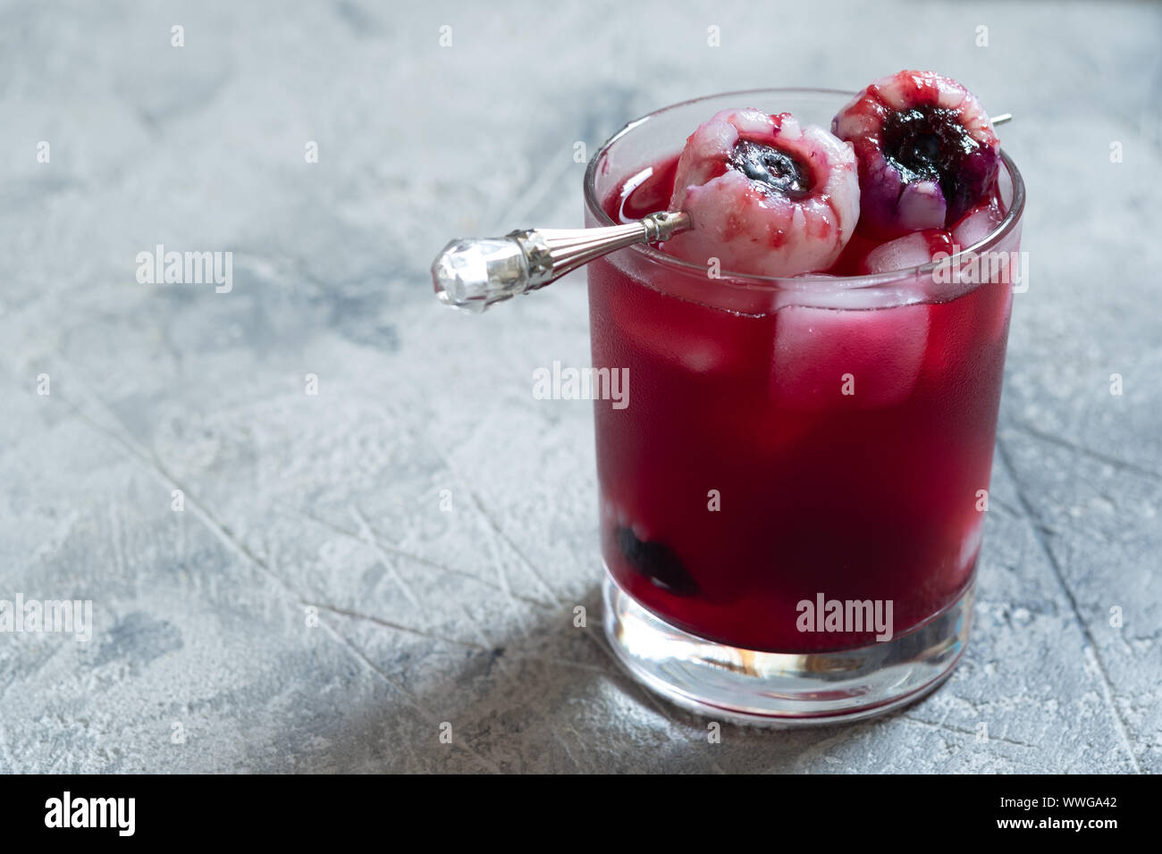 Red halloween cocktail with lychee and blueberry eye Stock Photo - Alamy