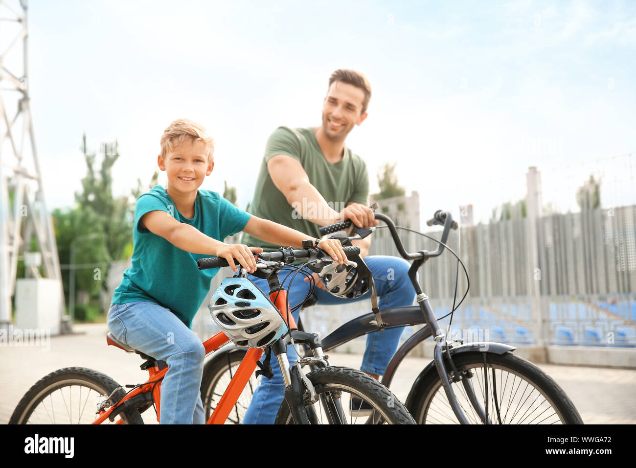 Happy father and son riding bicycles outdoors Stock Photo - Alamy