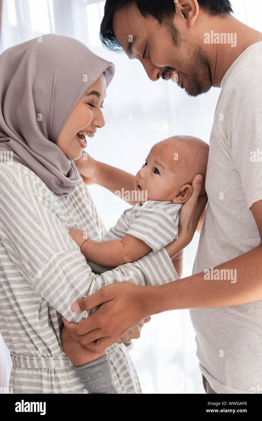 muslim asian parent playing at home with their baby Stock Photo - Alamy