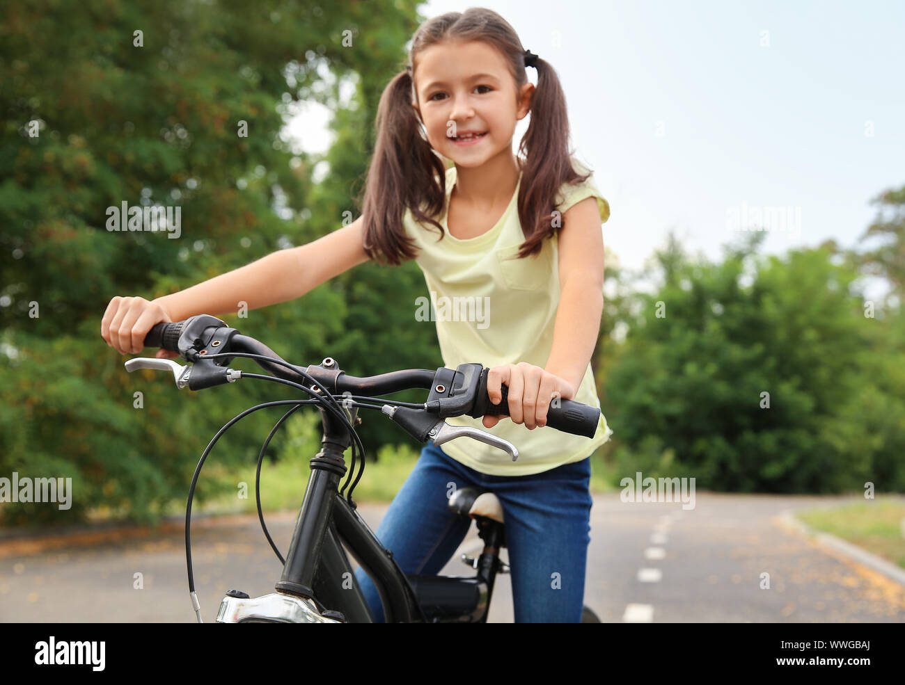 Little girl riding bicycle outdoors Stock Photo - Alamy
