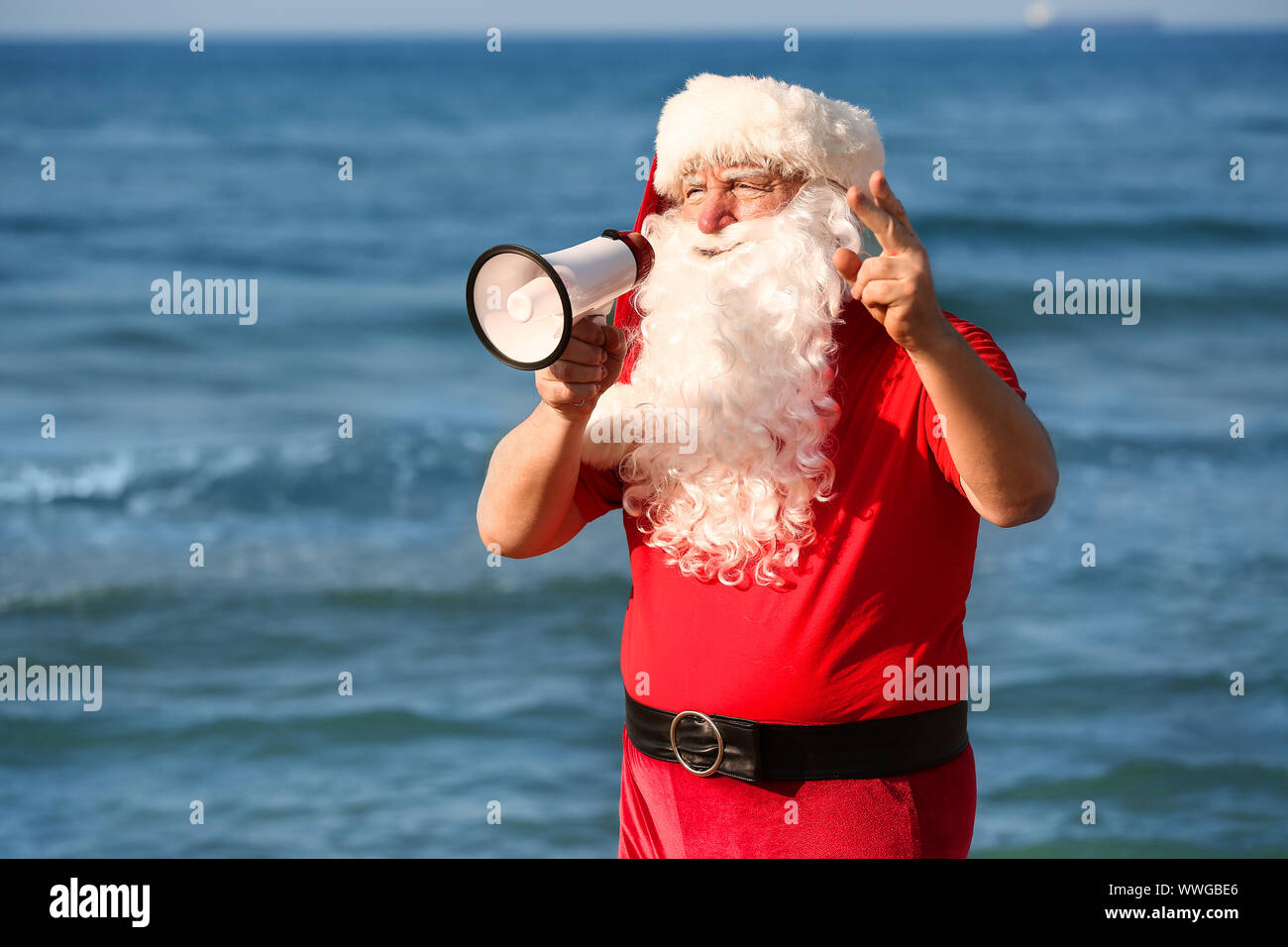 Screaming Santa Claus with megaphone at sea resort Stock Photo - Alamy