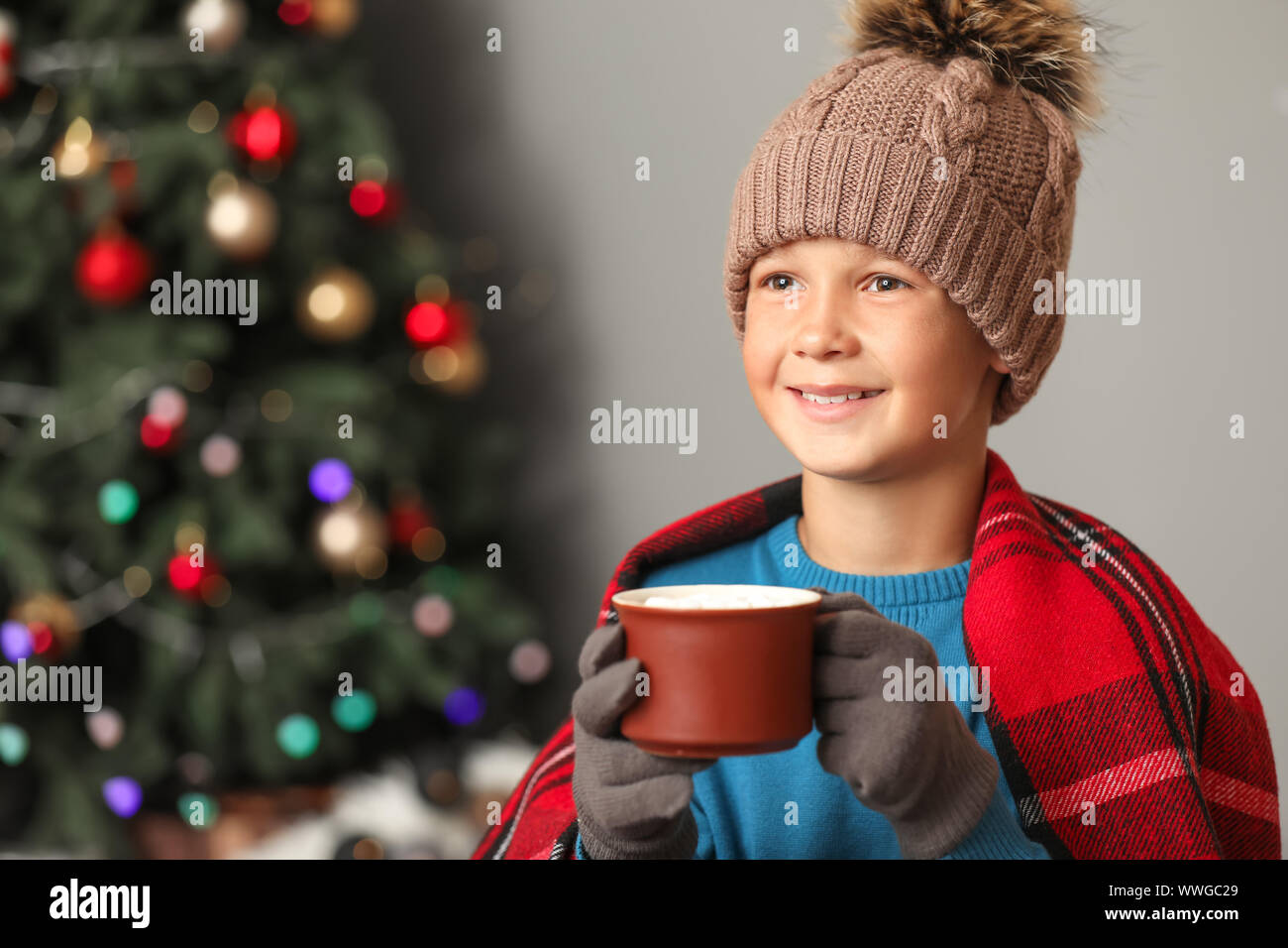 Cute little boy drinking hot chocolate at home on Christmas eve Stock ...