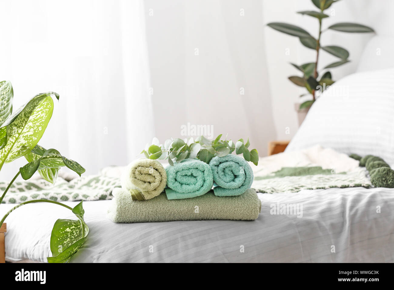 Clean soft towels on bed Stock Photo - Alamy