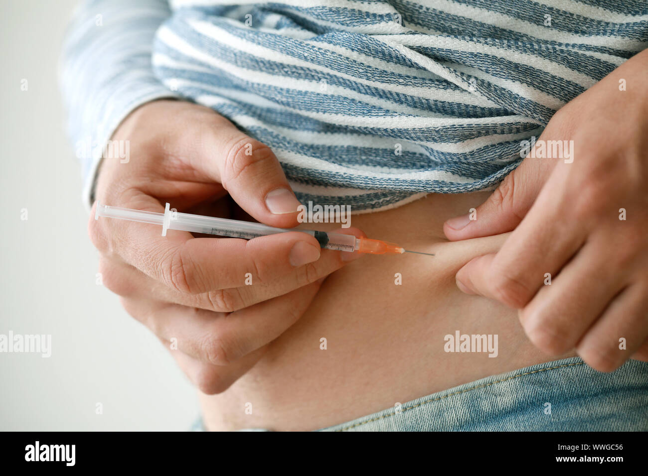 Diabetic man giving himself insulin injection at home, closeup Stock ...
