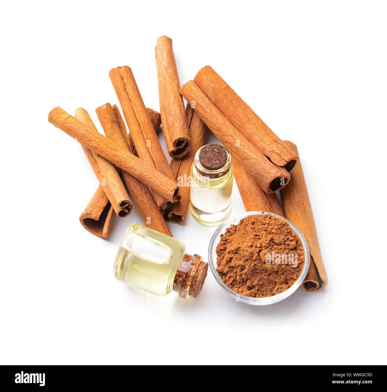 Aromatic cinnamon sticks and essential oil on white background Stock ...