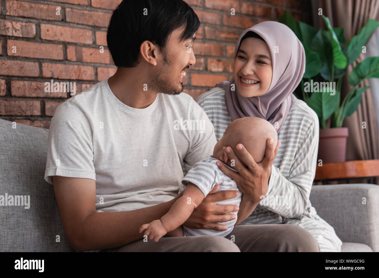 muslim asian parent playing at home with their baby Stock Photo - Alamy