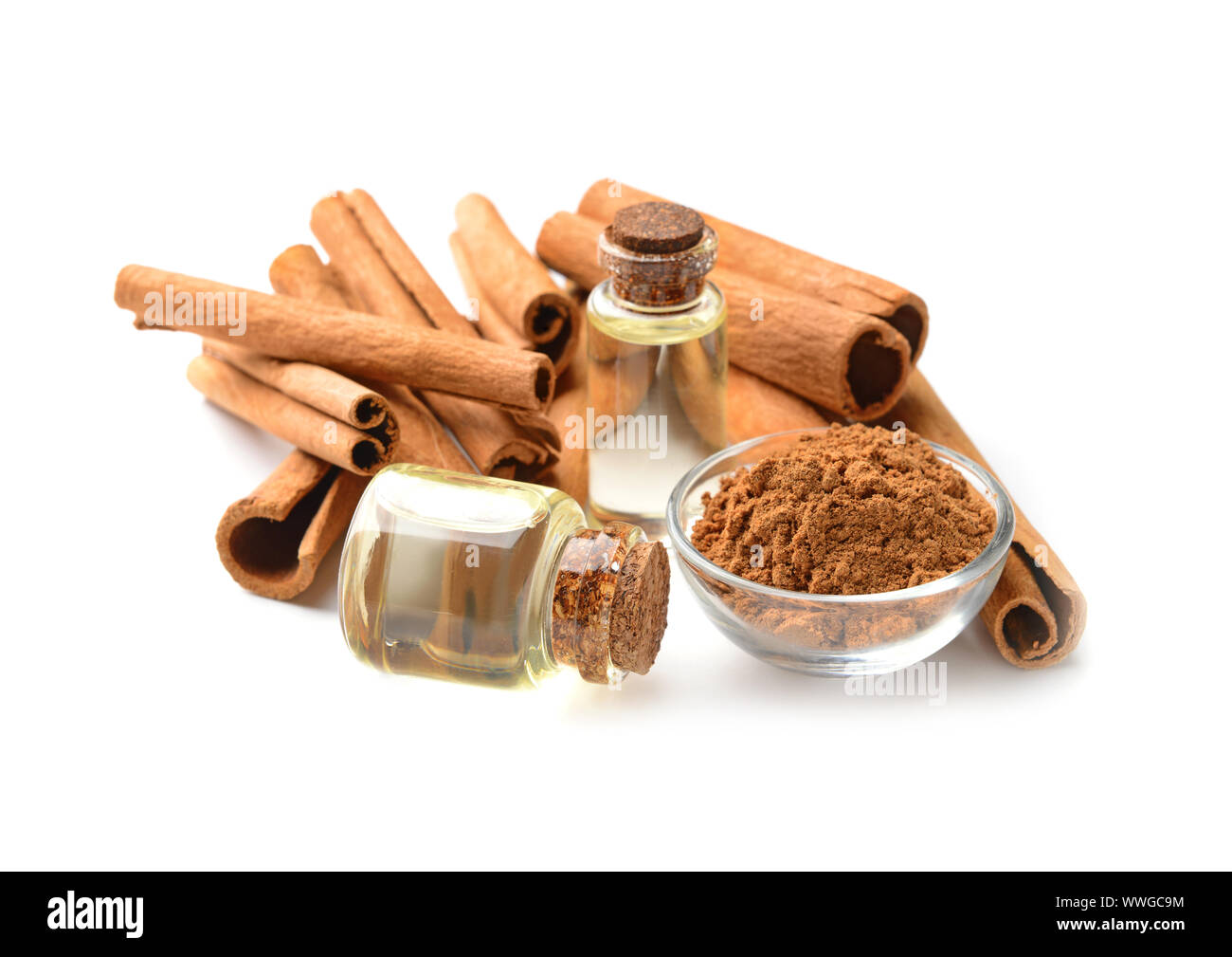 Aromatic cinnamon sticks and essential oil on white background Stock ...