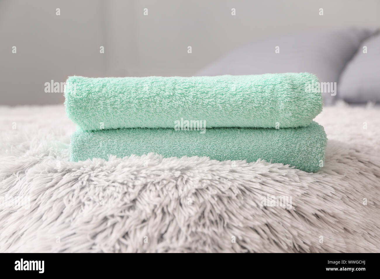 Stack of clean towels on bed Stock Photo - Alamy