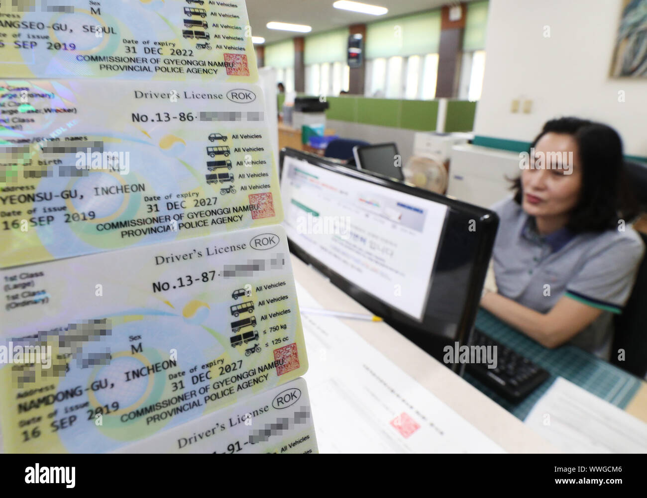 16th Sep, 2019. Driver's license in English An official shows off new ...