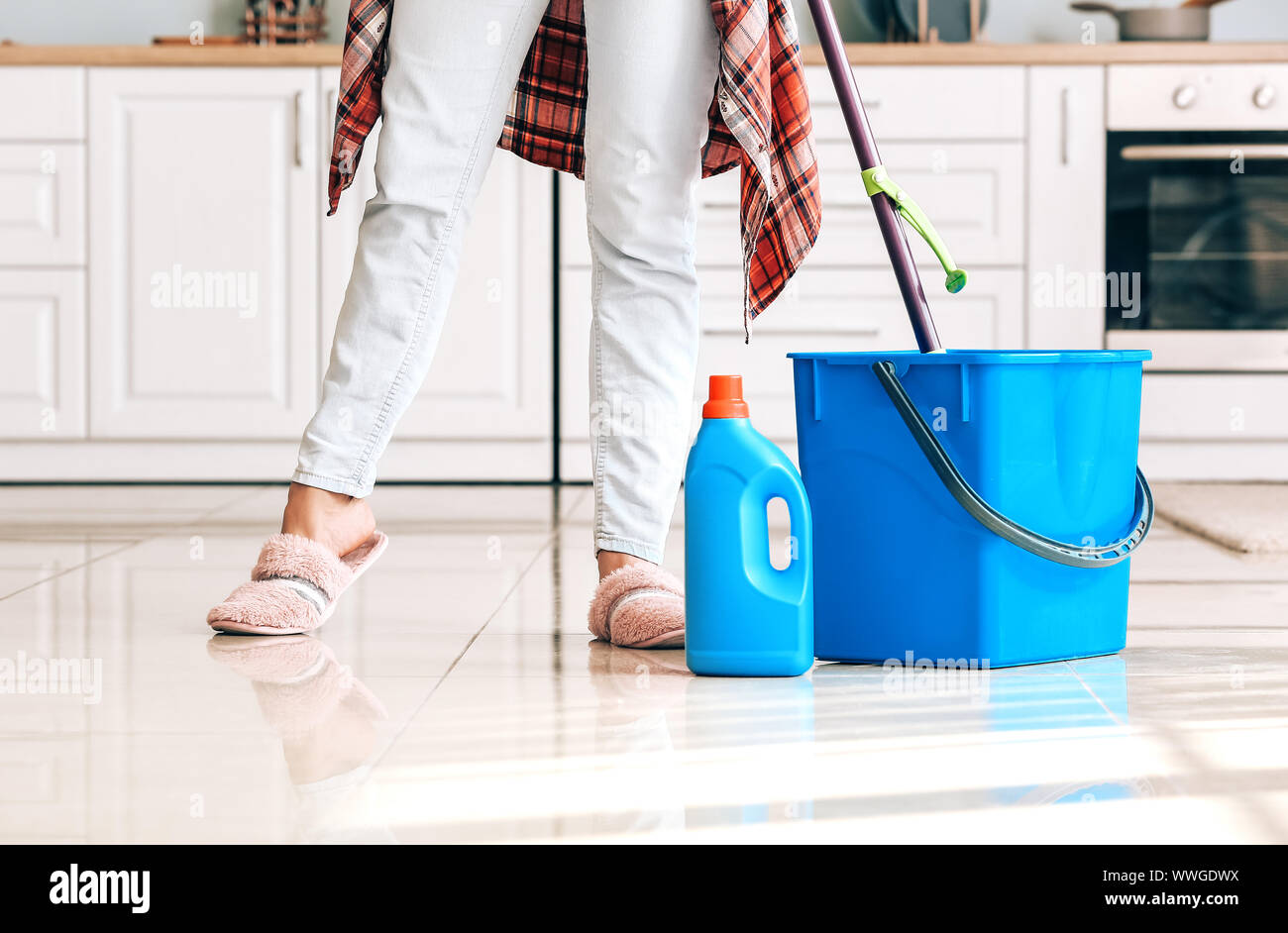 Woman cleaning floor in kitchen Stock Photo - Alamy