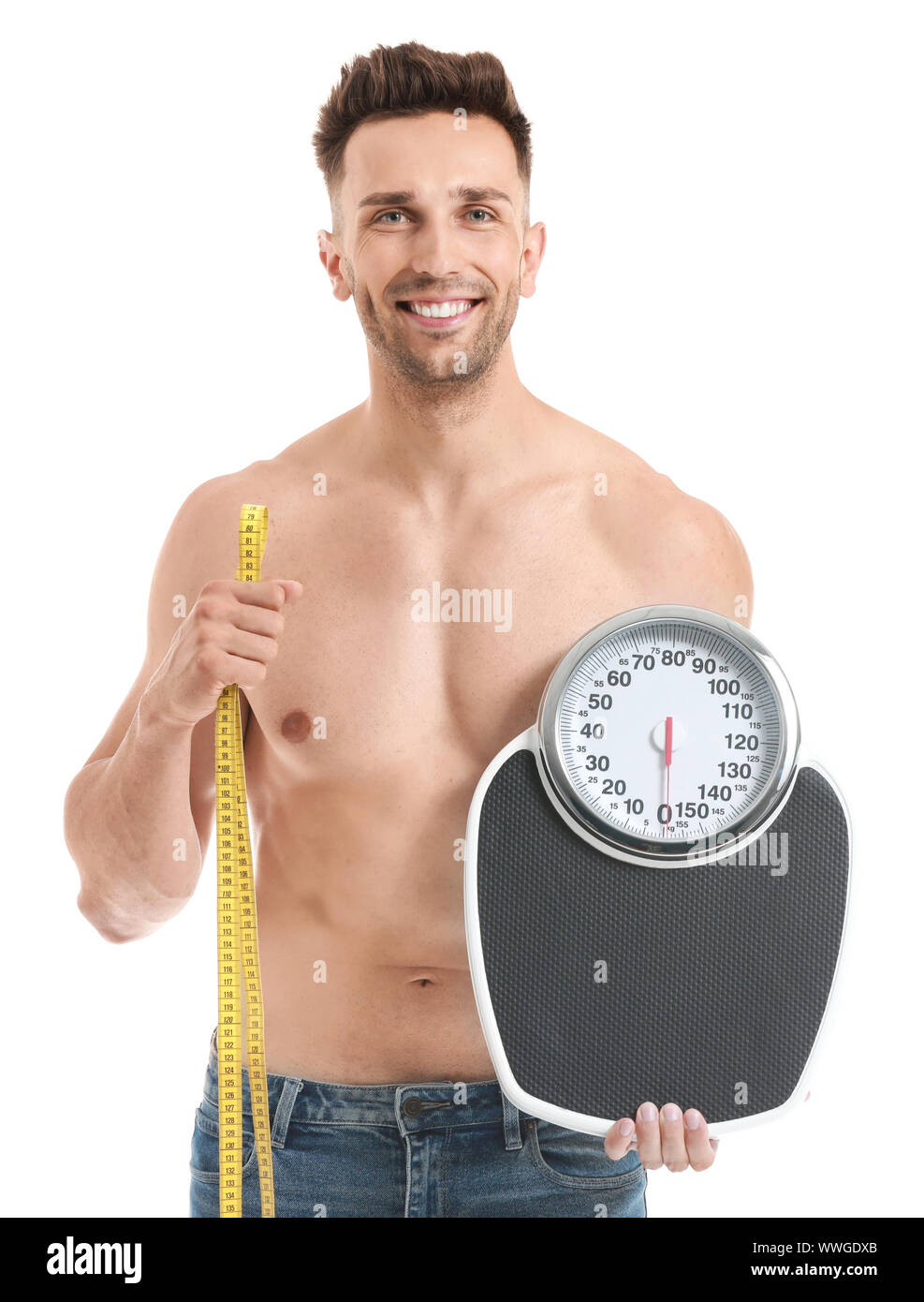 Handsome muscular man with measuring tape and scales on white ...