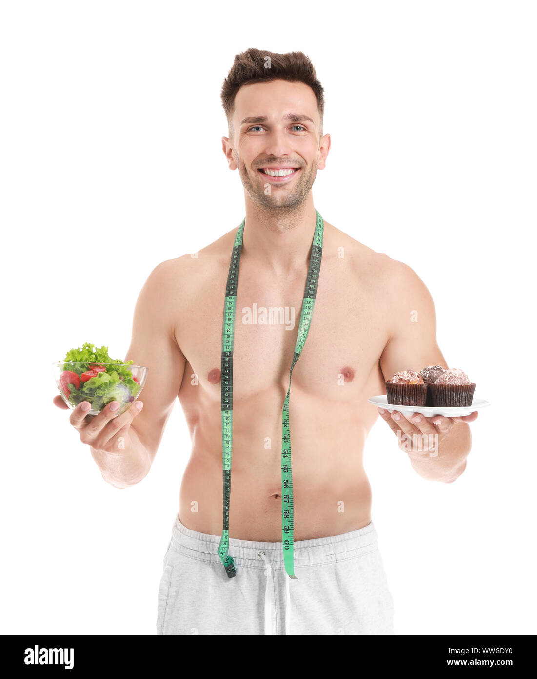 Handsome muscular man with measuring tape and food on white background ...