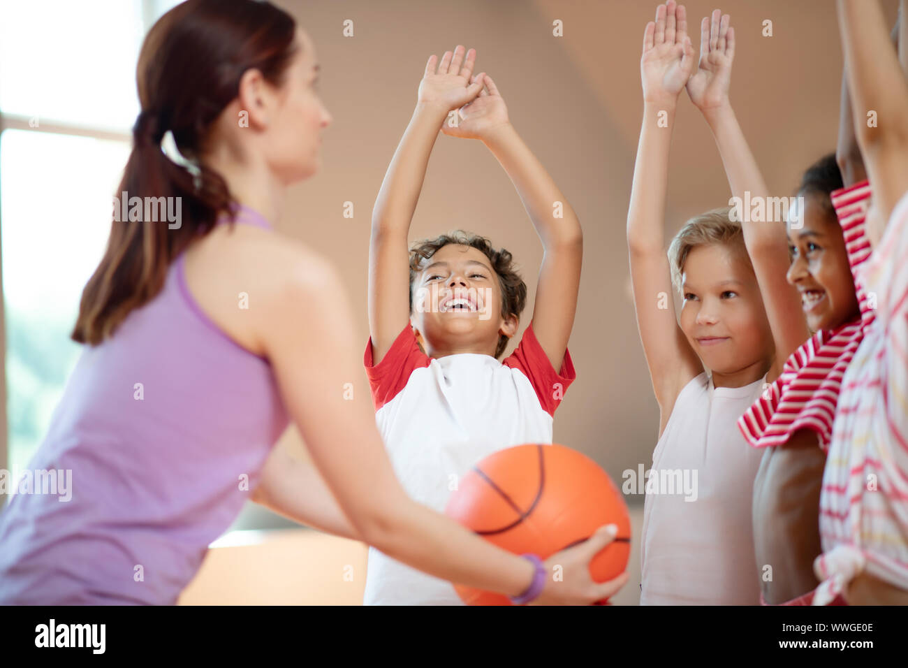 Children cheering up before playing basketball together Stock Photo - Alamy