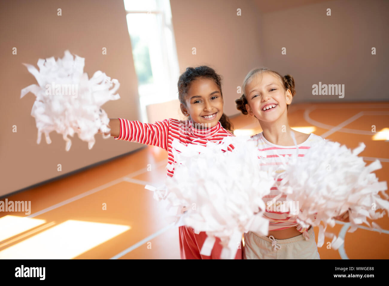 Best friends smiling while practicing cheerleading together Stock Photo ...
