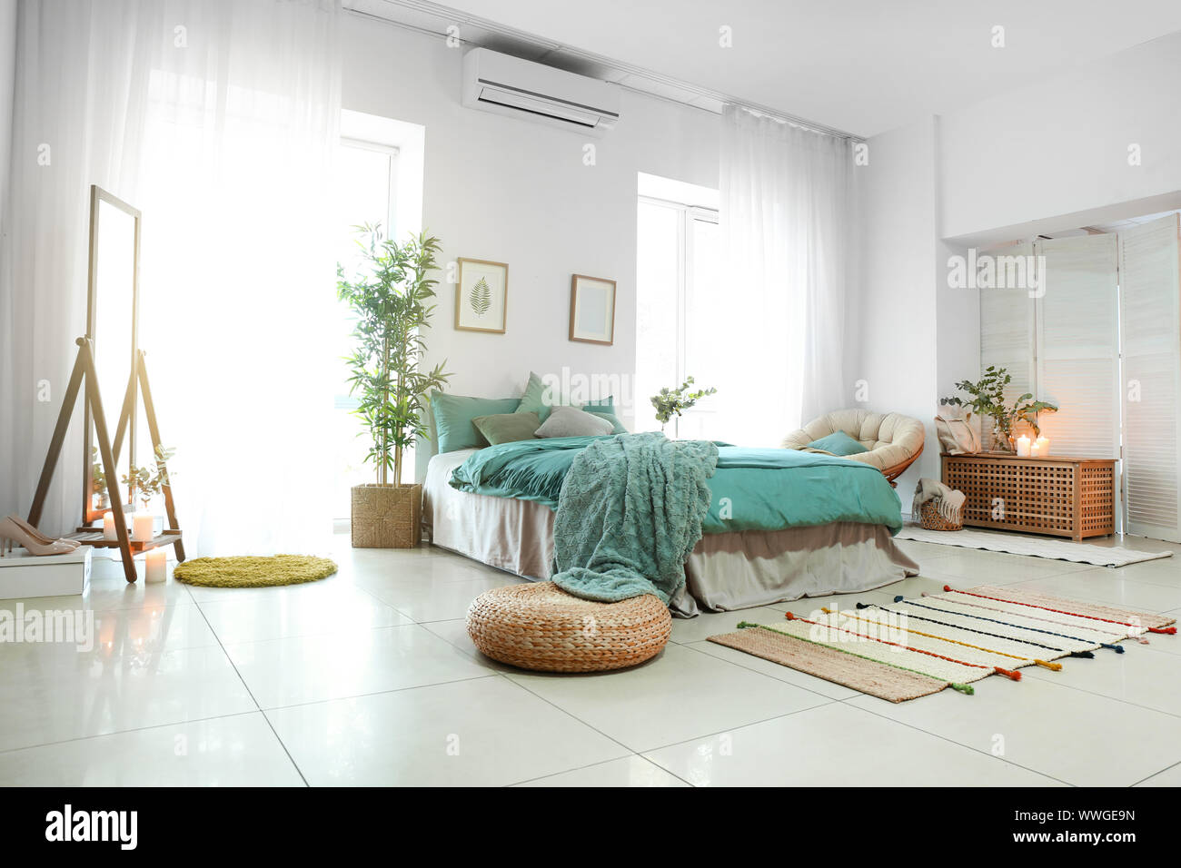 Stylish interior of room with big comfortable bed Stock Photo - Alamy