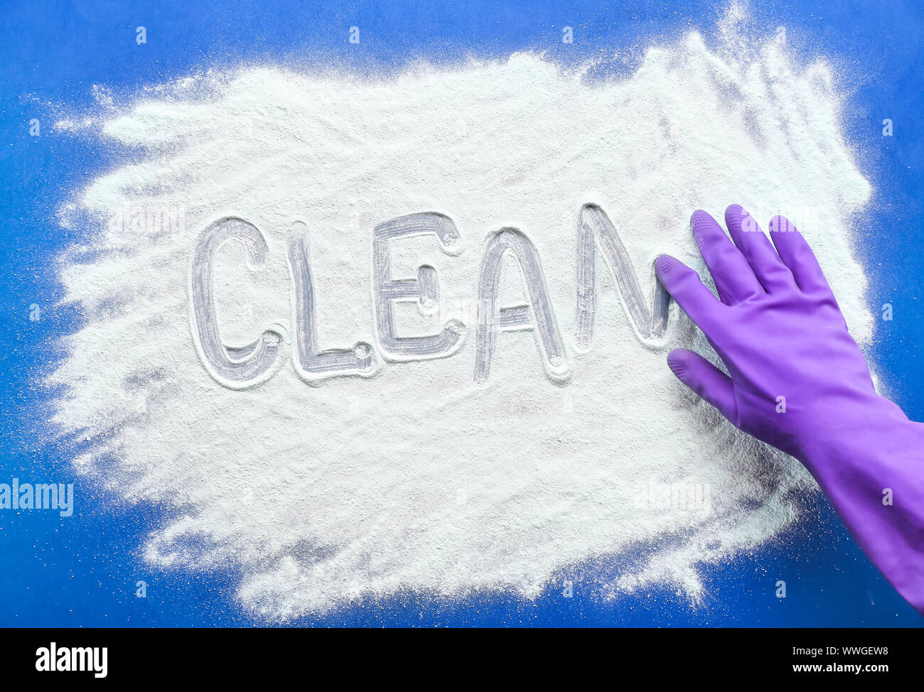 Hand in glove writing word CLEAN on detergent Stock Photo - Alamy
