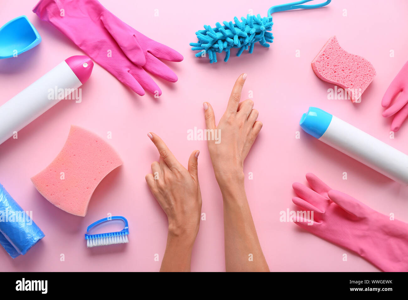 Female hands with cleaning supplies on color background Stock Photo - Alamy