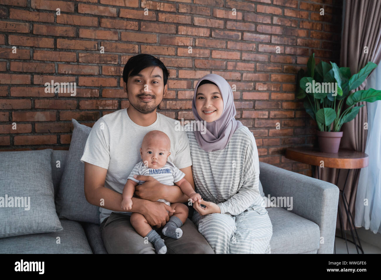 muslim parent with baby boy smiling to camera Stock Photo - Alamy