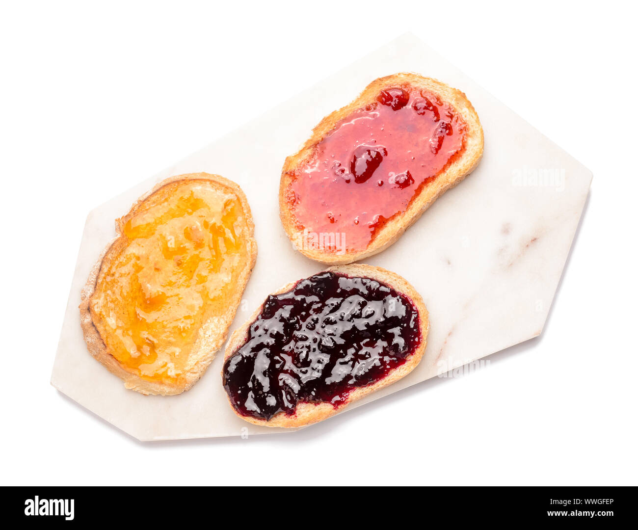 Board with tasty toasted bread and jams on white background Stock Photo ...