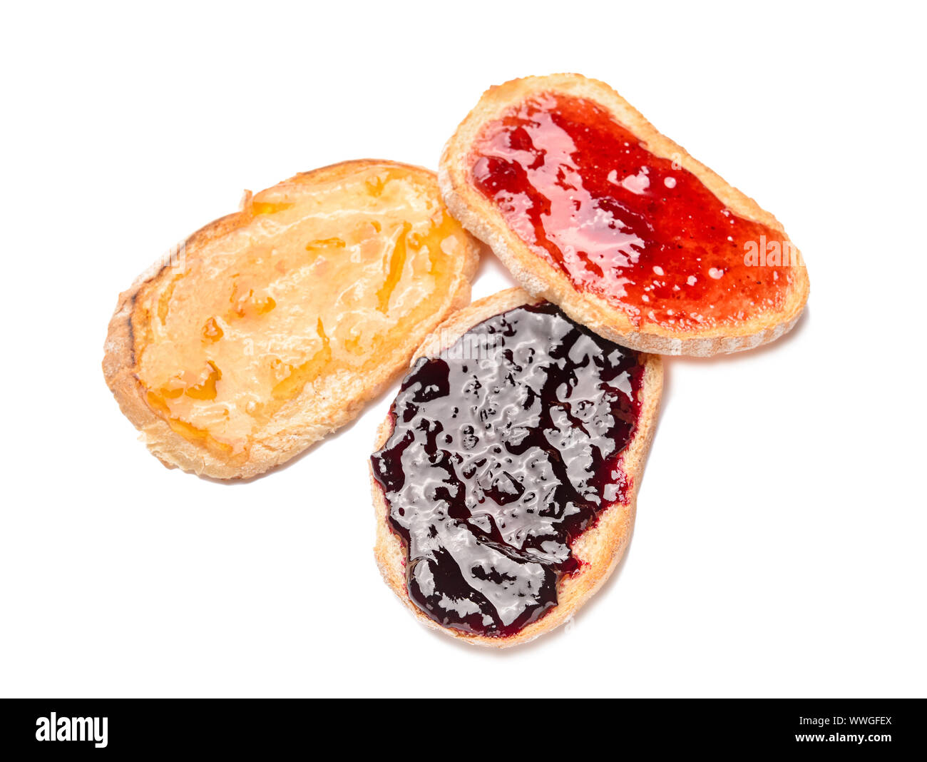 Tasty toasted bread with different jams on white background Stock Photo ...
