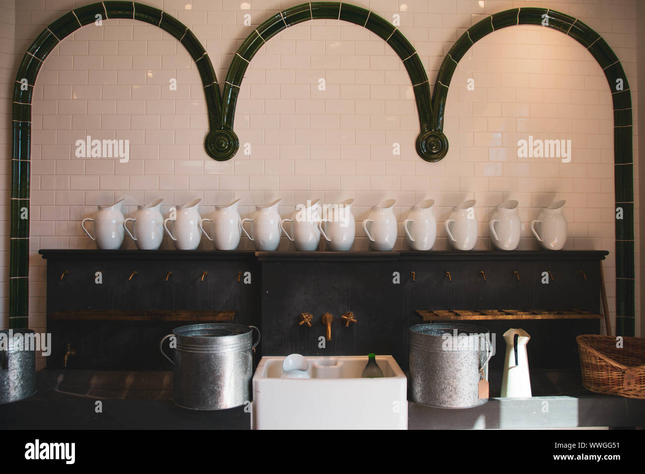 Industrial, vintage style dual sink set up with subway tiles in the ...