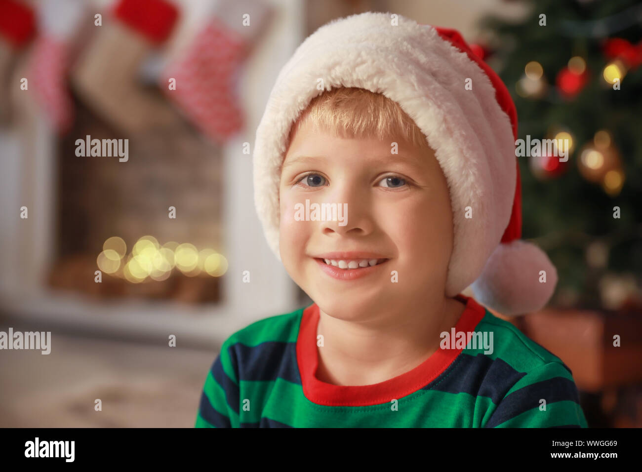 Cute little boy in Santa Claus hat at home Stock Photo - Alamy