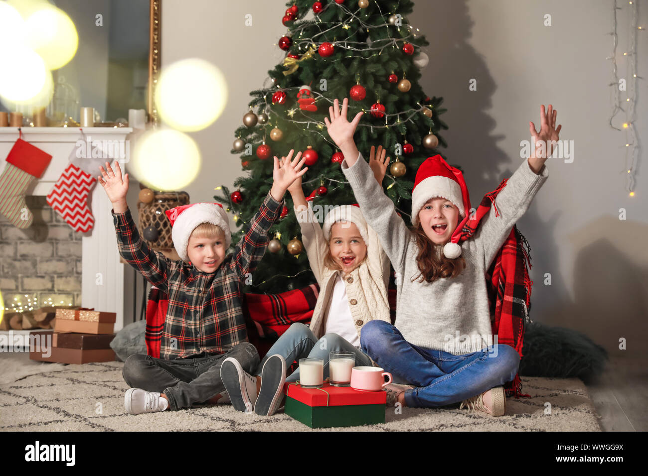 Happy little children on Christmas eve at home Stock Photo - Alamy