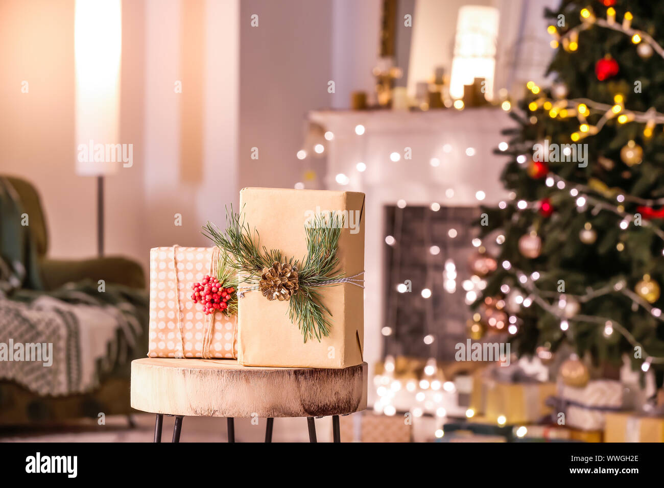 Beautiful Christmas gift boxes on table in room Stock Photo - Alamy