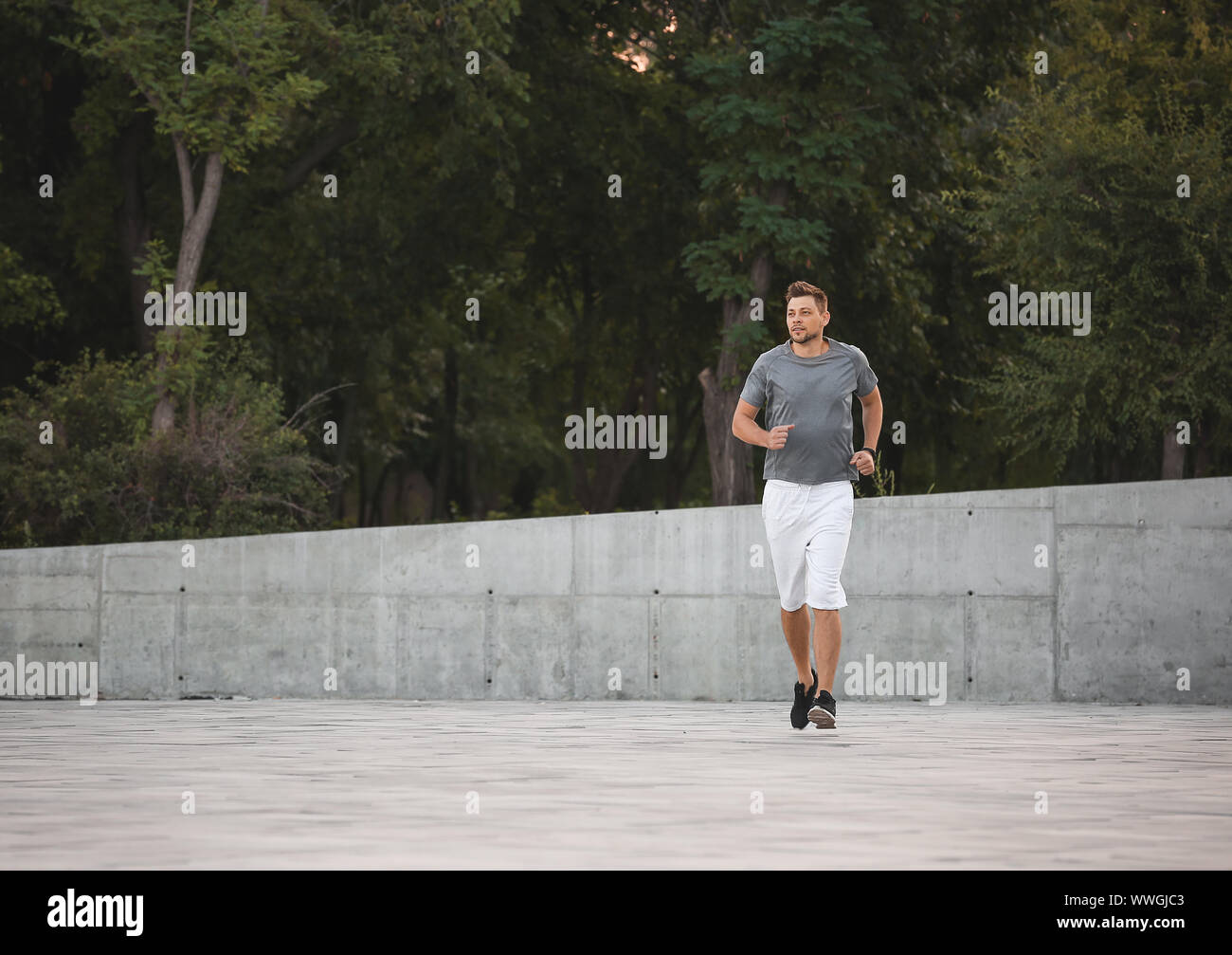 Handsome sporty man running hi-res stock photography and images - Alamy