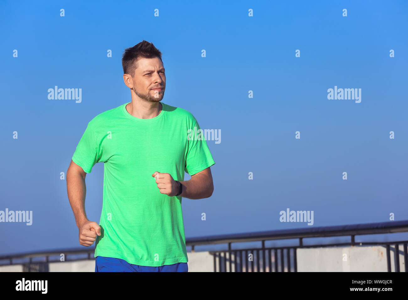 Handsome sporty man running outdoors Stock Photo - Alamy