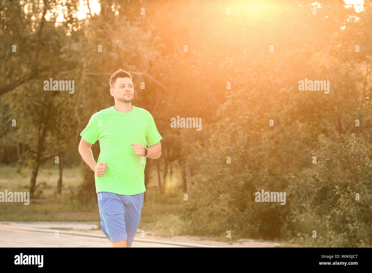 Handsome sporty man running outdoors Stock Photo - Alamy