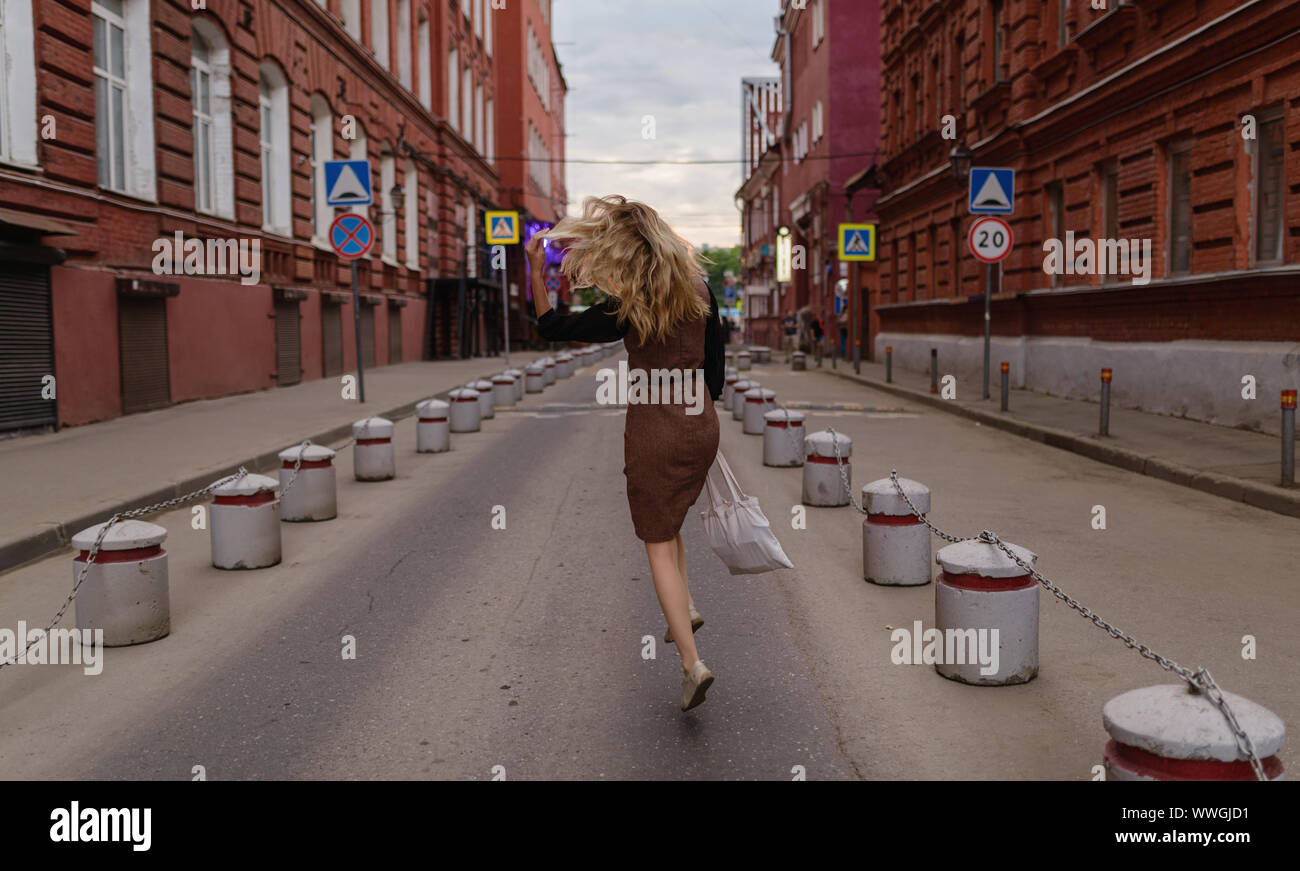 Portrait of beautiful young woman - she run down the street Stock Photo ...