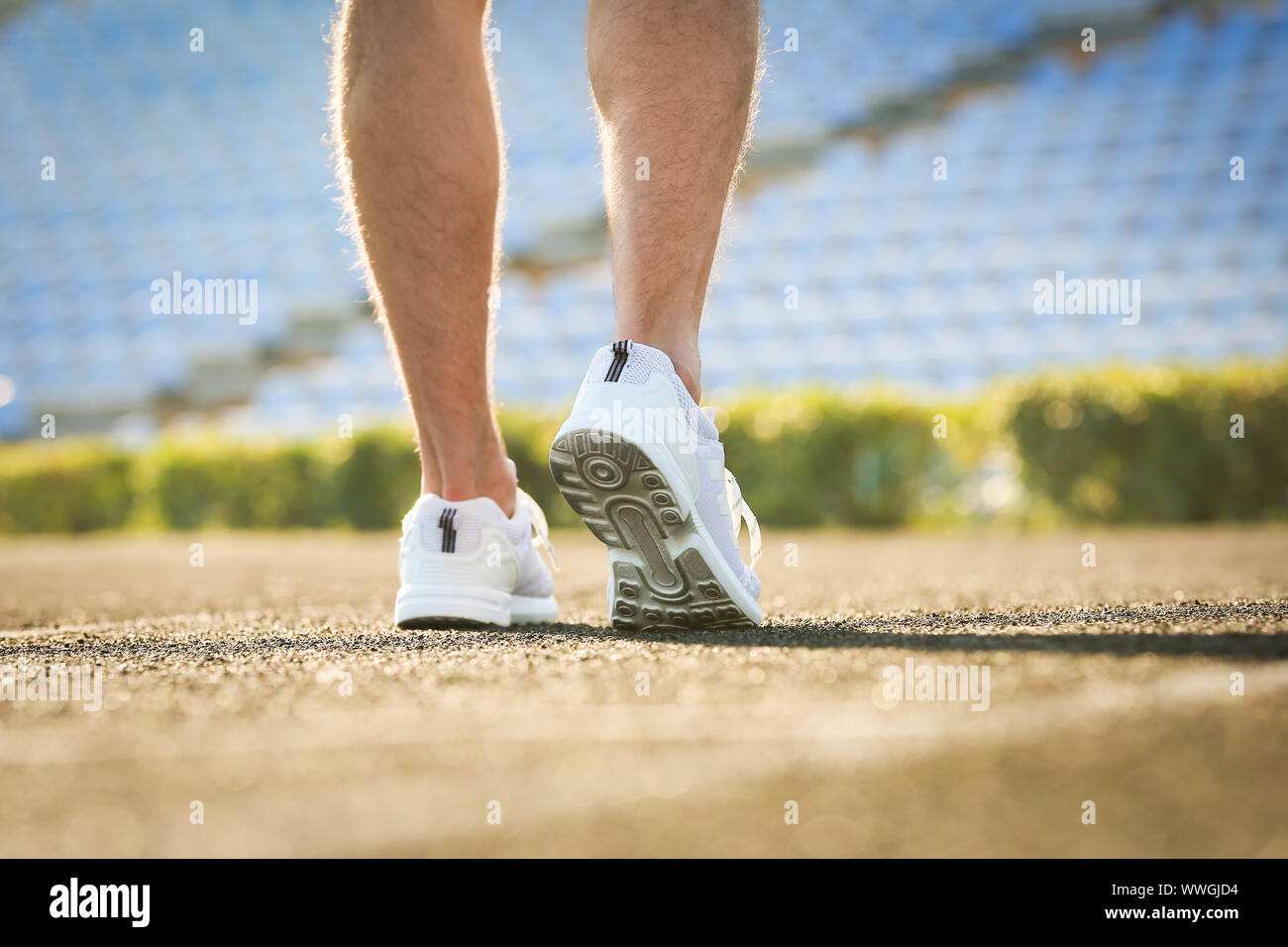 Sporty man running at the stadium, closeup Stock Photo - Alamy