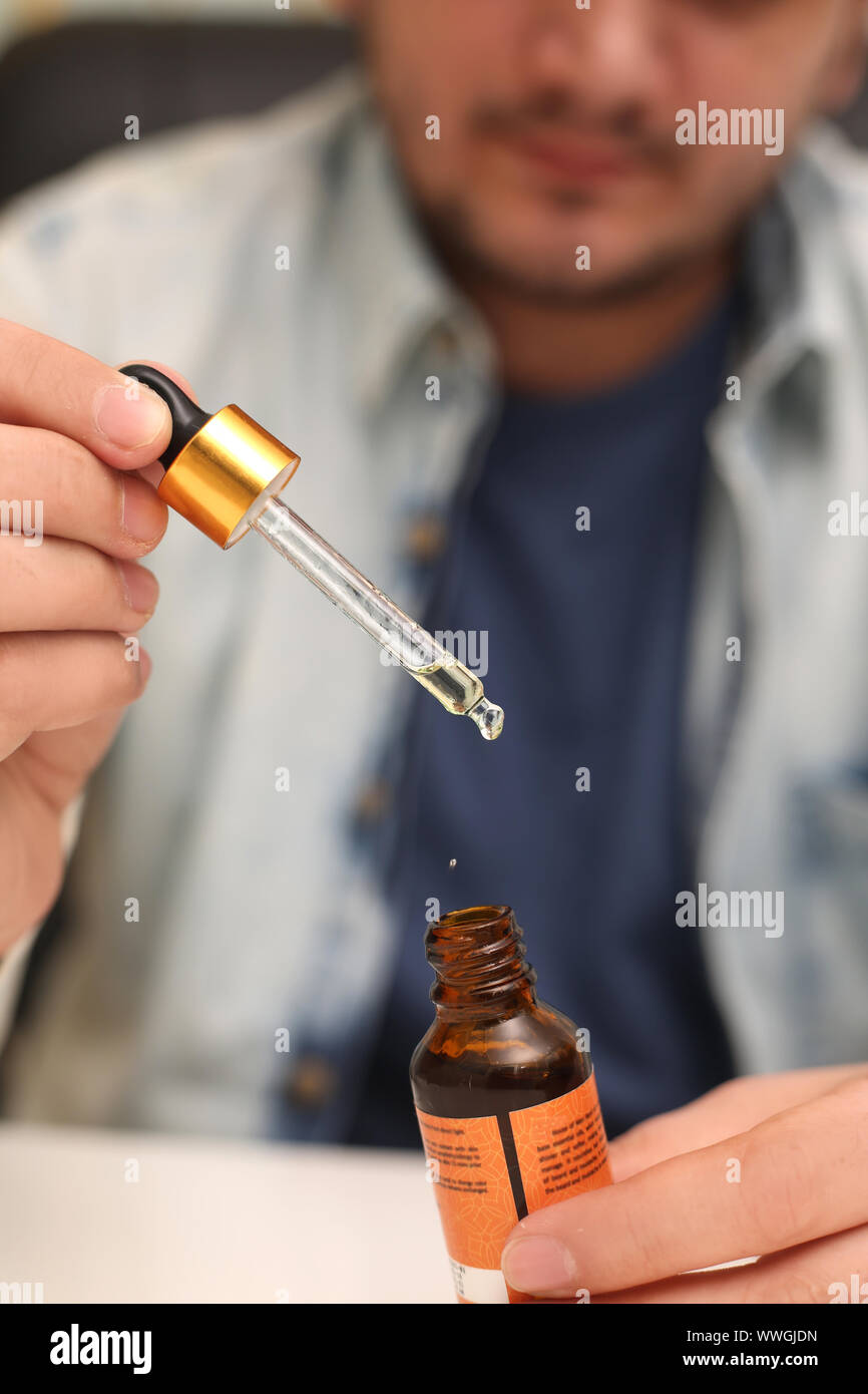 Picture of man drops medicine bottle holding in hand. Isolated on white ...