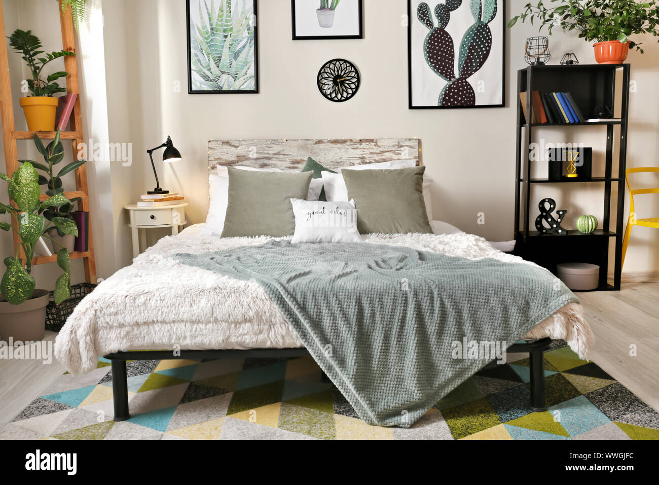 Big comfortable bed in stylish interior of room Stock Photo - Alamy