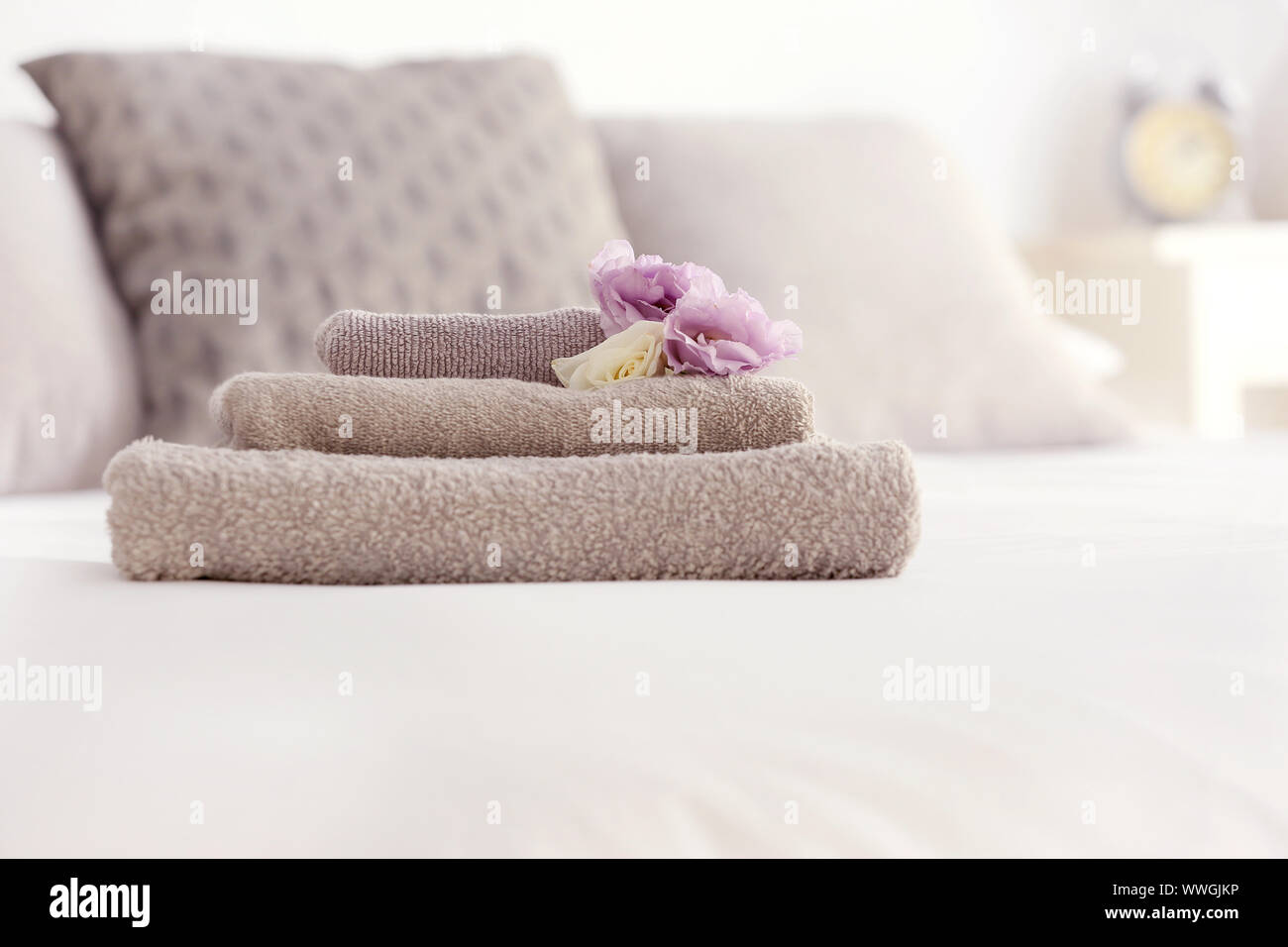 Stack of clean towels on bed Stock Photo - Alamy