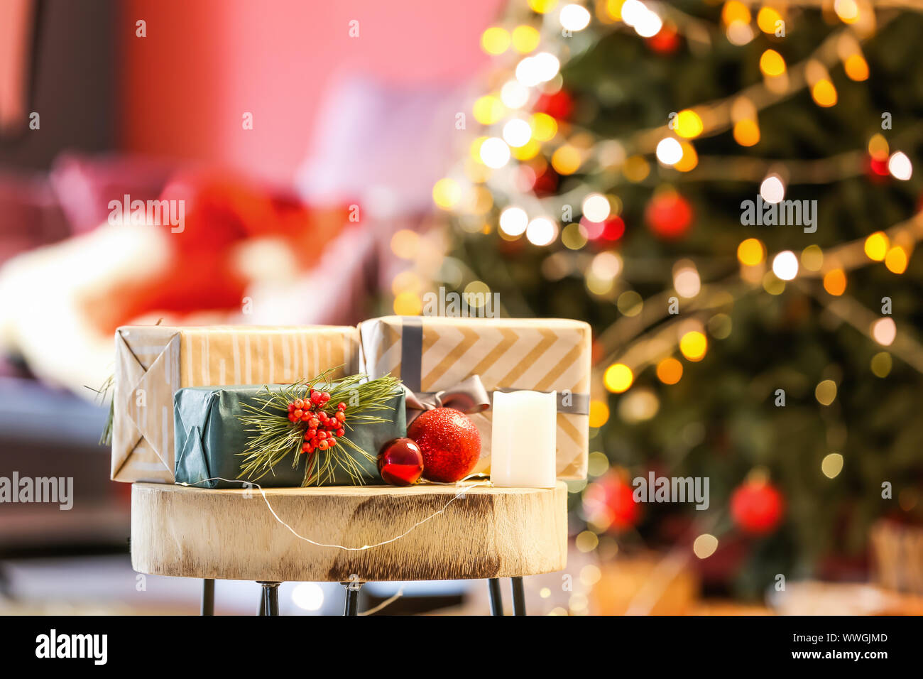 Beautiful Christmas gift boxes on table in room Stock Photo - Alamy