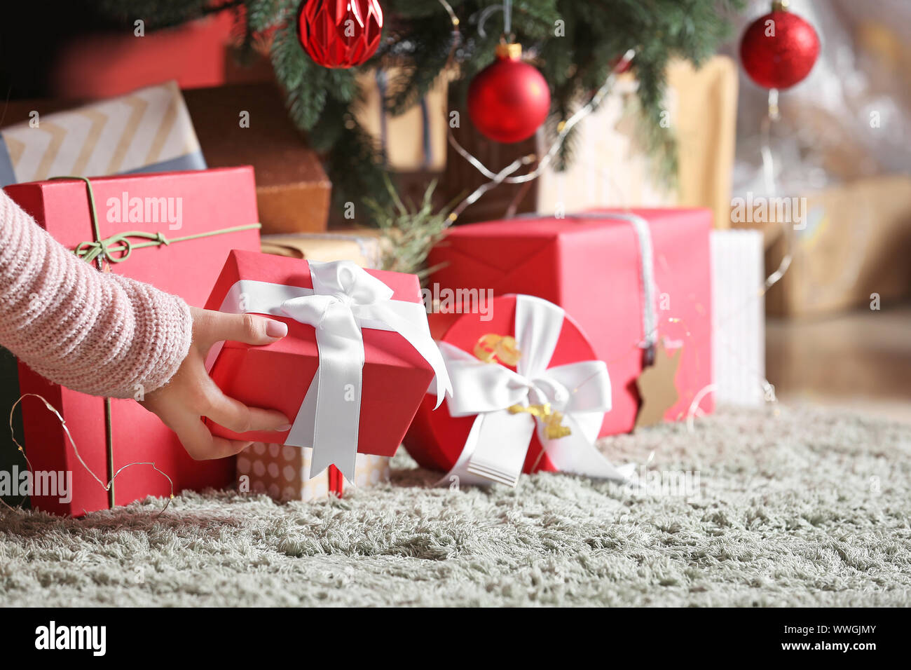 Woman putting gift boxes hi-res stock photography and images - Alamy